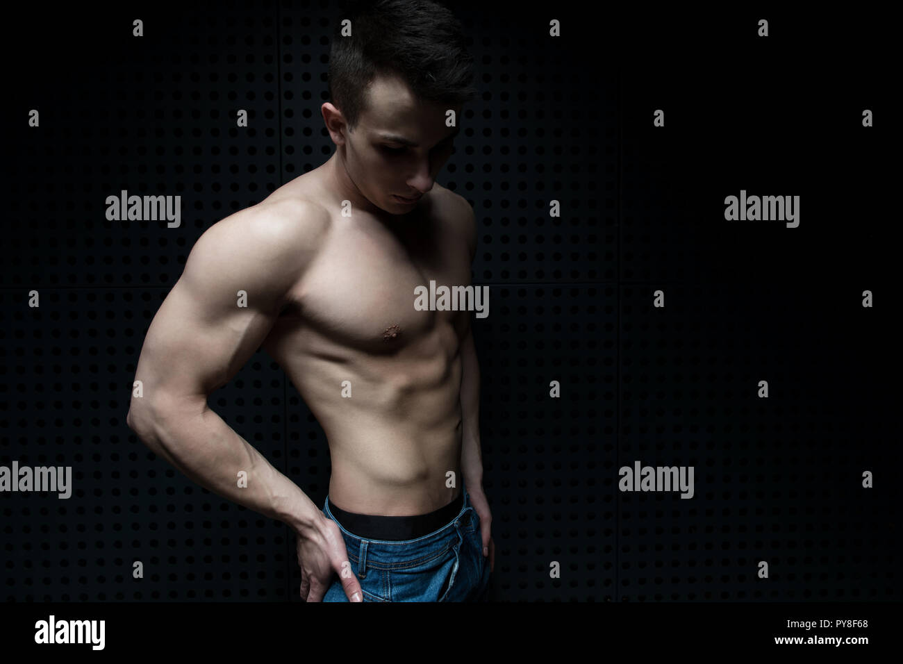 Healthy Young Man Standing Strong Standing Against a Wall and Flexing ...