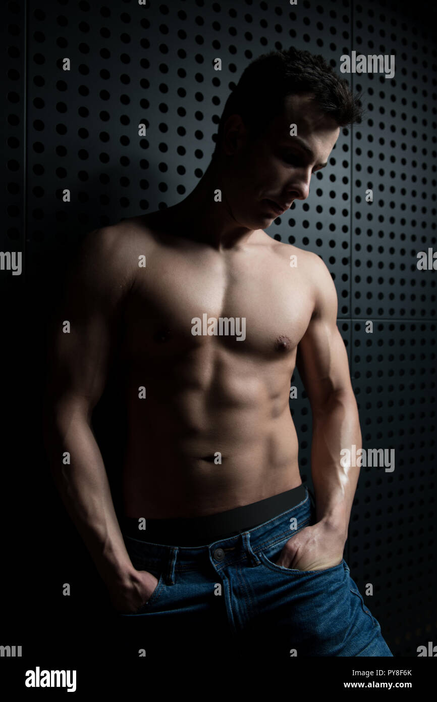 Healthy Young Man Standing Strong Standing Against a Wall and Flexing ...