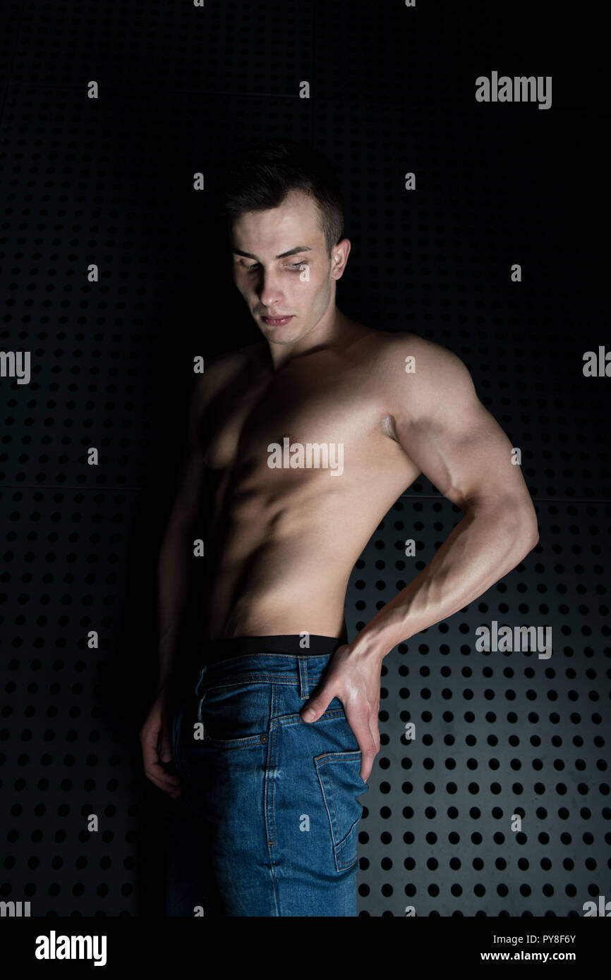 Healthy Young Man Standing Strong Standing Against a Wall and Flexing ...