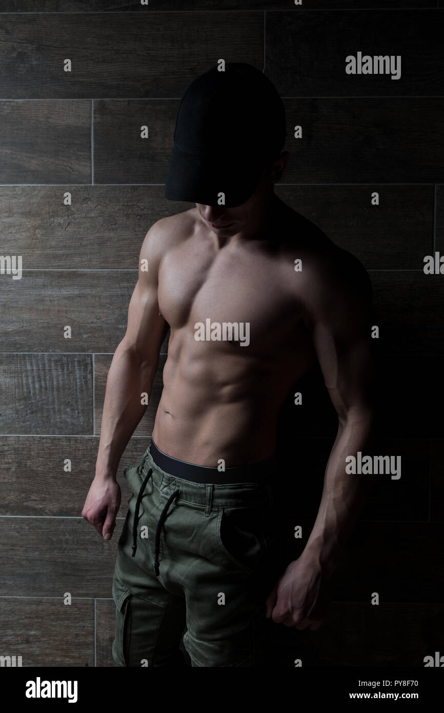 Healthy Young Man Standing Strong Standing Against a Wall and Flexing ...
