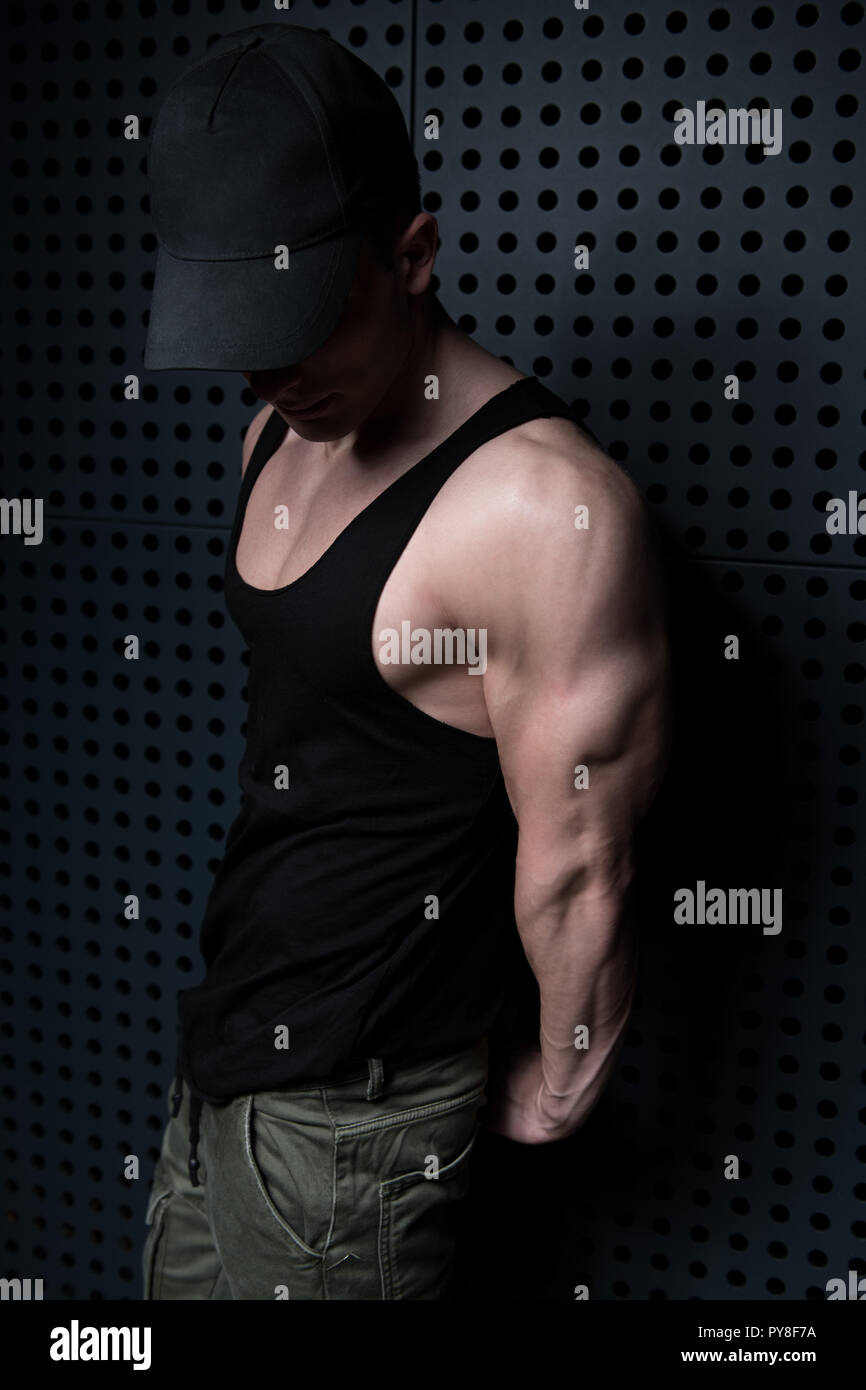 Healthy Young Man Standing Strong Standing Against a Wall and Flexing ...