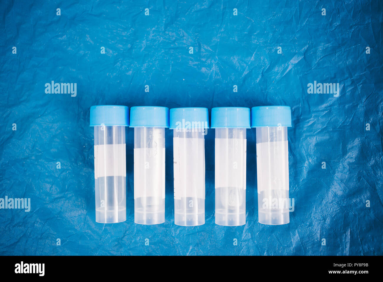 tube for sampling biological material on a blue background, top view ...