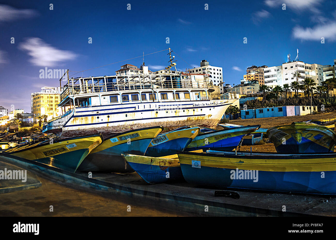A photo of Old wooden boats at Gaza seaport, Night photo Stock Photo ...
