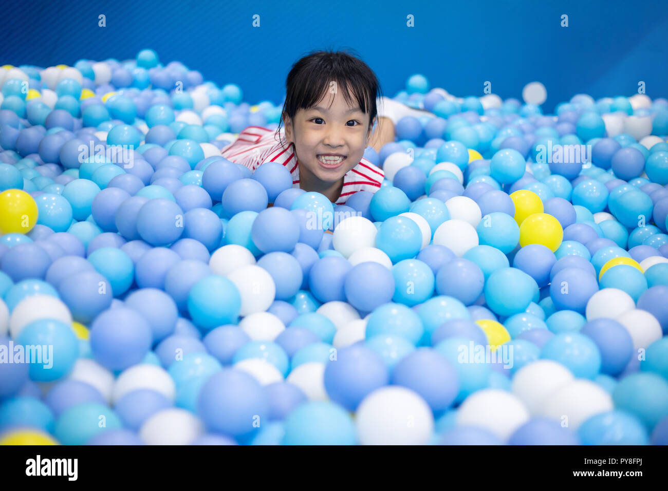 Asian Chinese little Girl Playing At Balls Pool in Indoor Playground ...