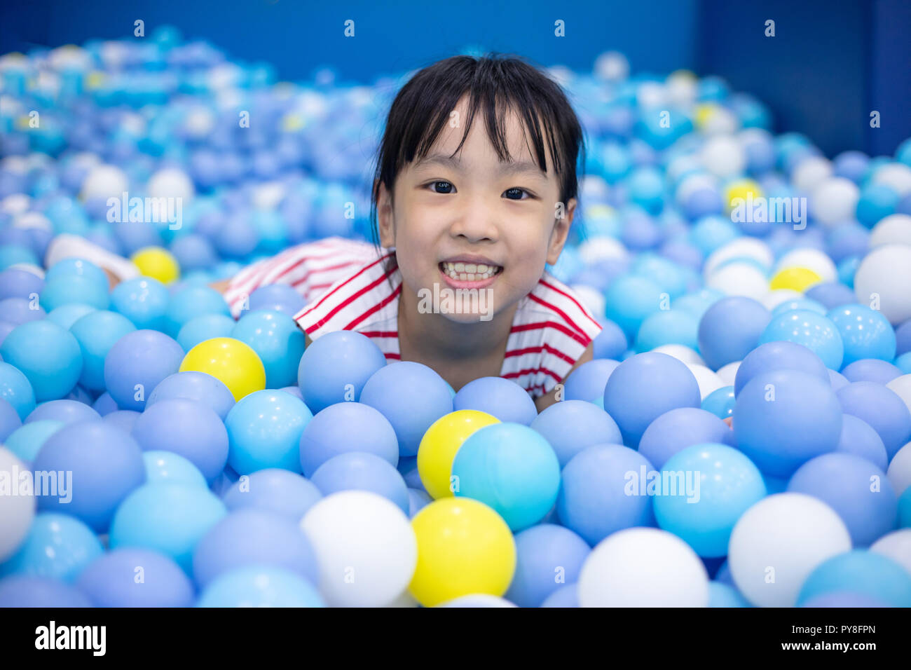 Asian Chinese little Girl Playing At Balls Pool in Indoor Playground ...