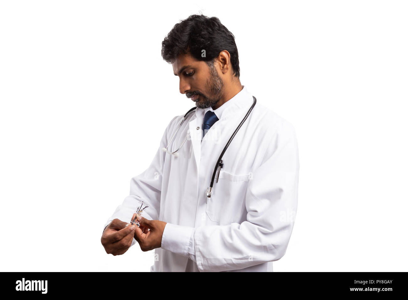 Indian optometrist doctor holding and looking at eyeglasses or ...