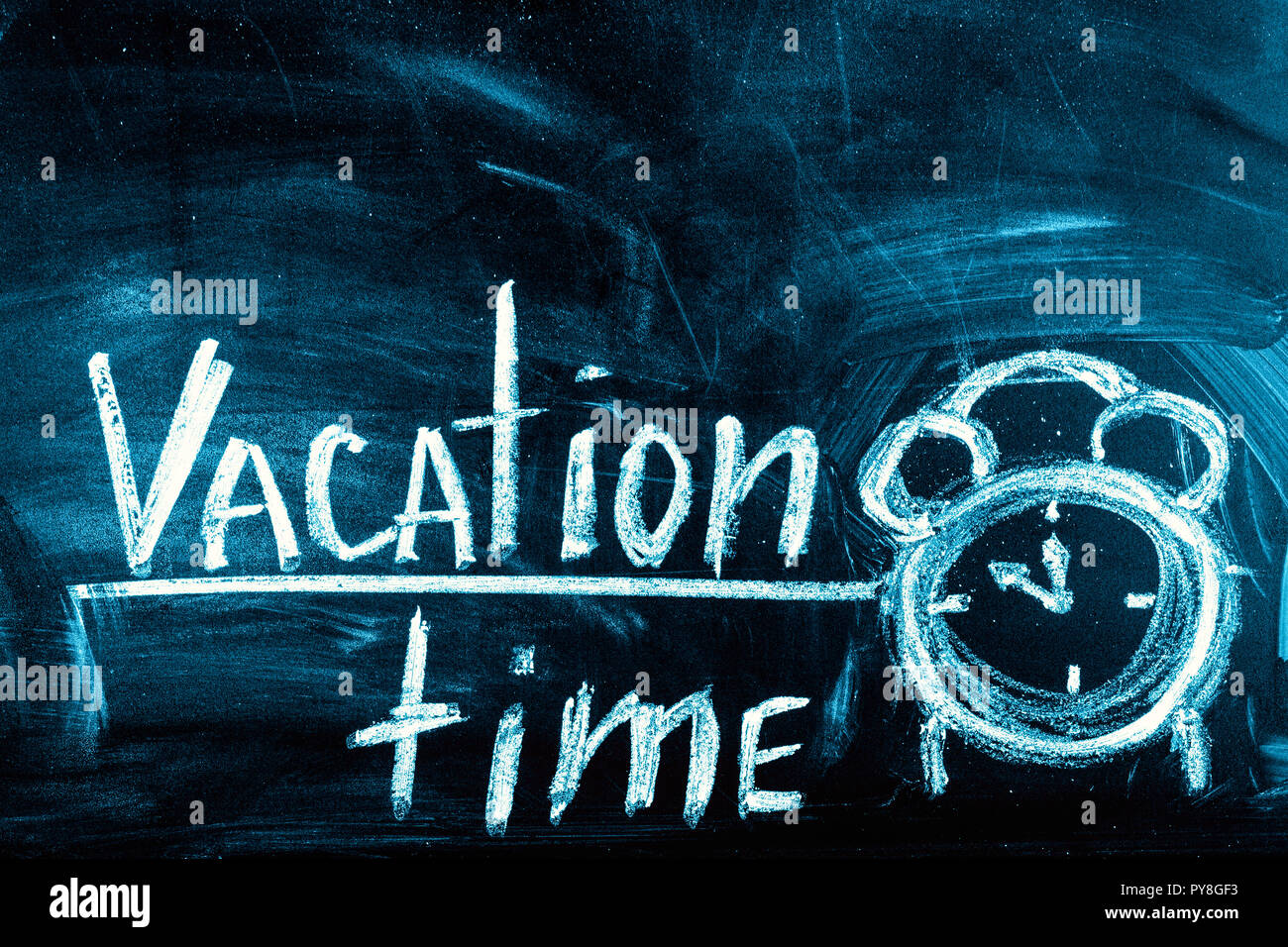 Vacation time near to a painted clock, inscribed in chalk on a ...