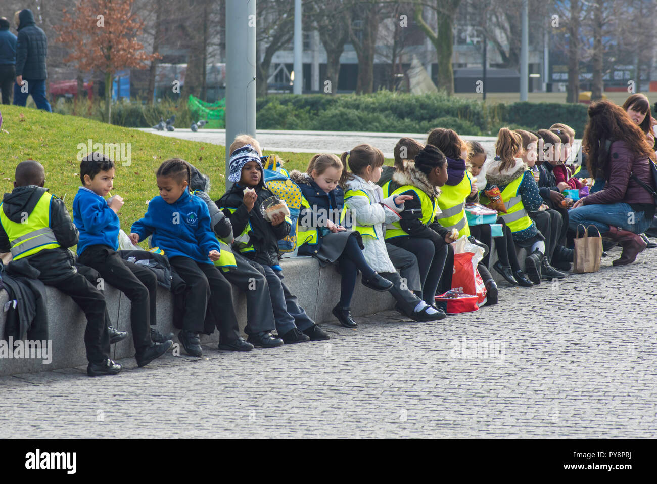 School children wearing high visibility jackets while out on a day trip ...