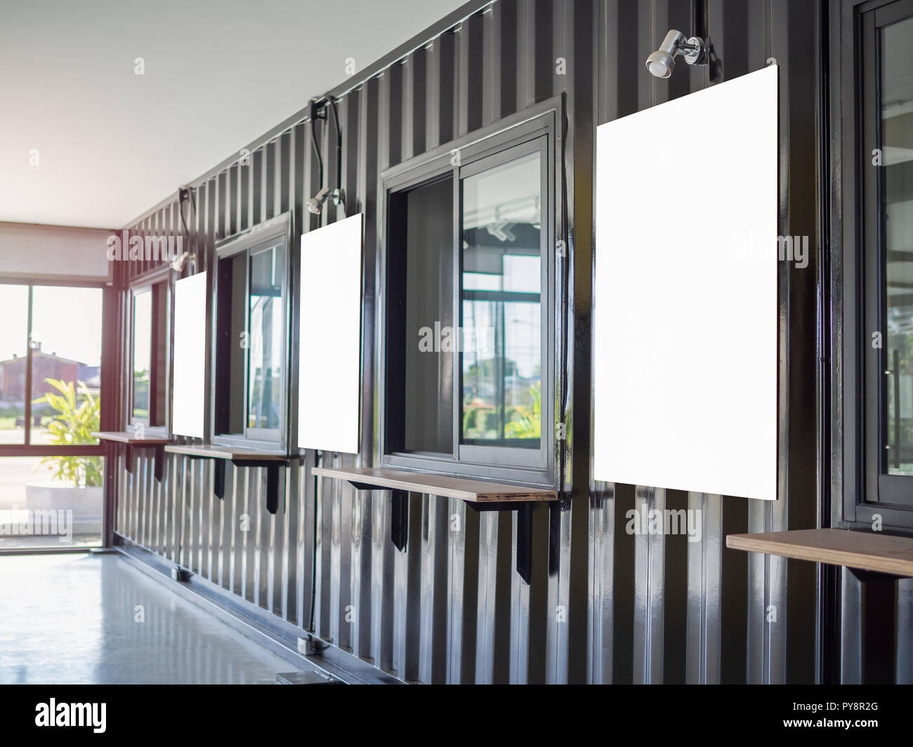 Row of blank white mock up poster frame on shipping container wall ...