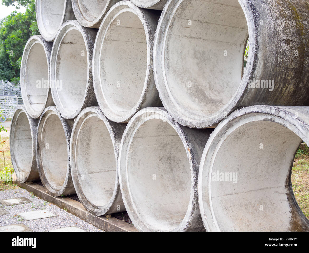 Row of concrete pipes for the construction of industrial buildings ...