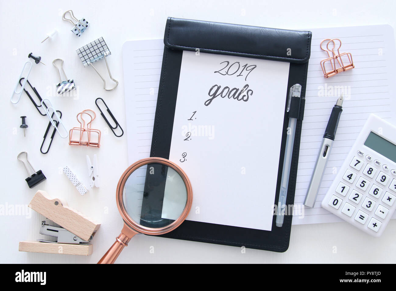 Top view 2019 goals list with notebook and calculator over wooden white ...