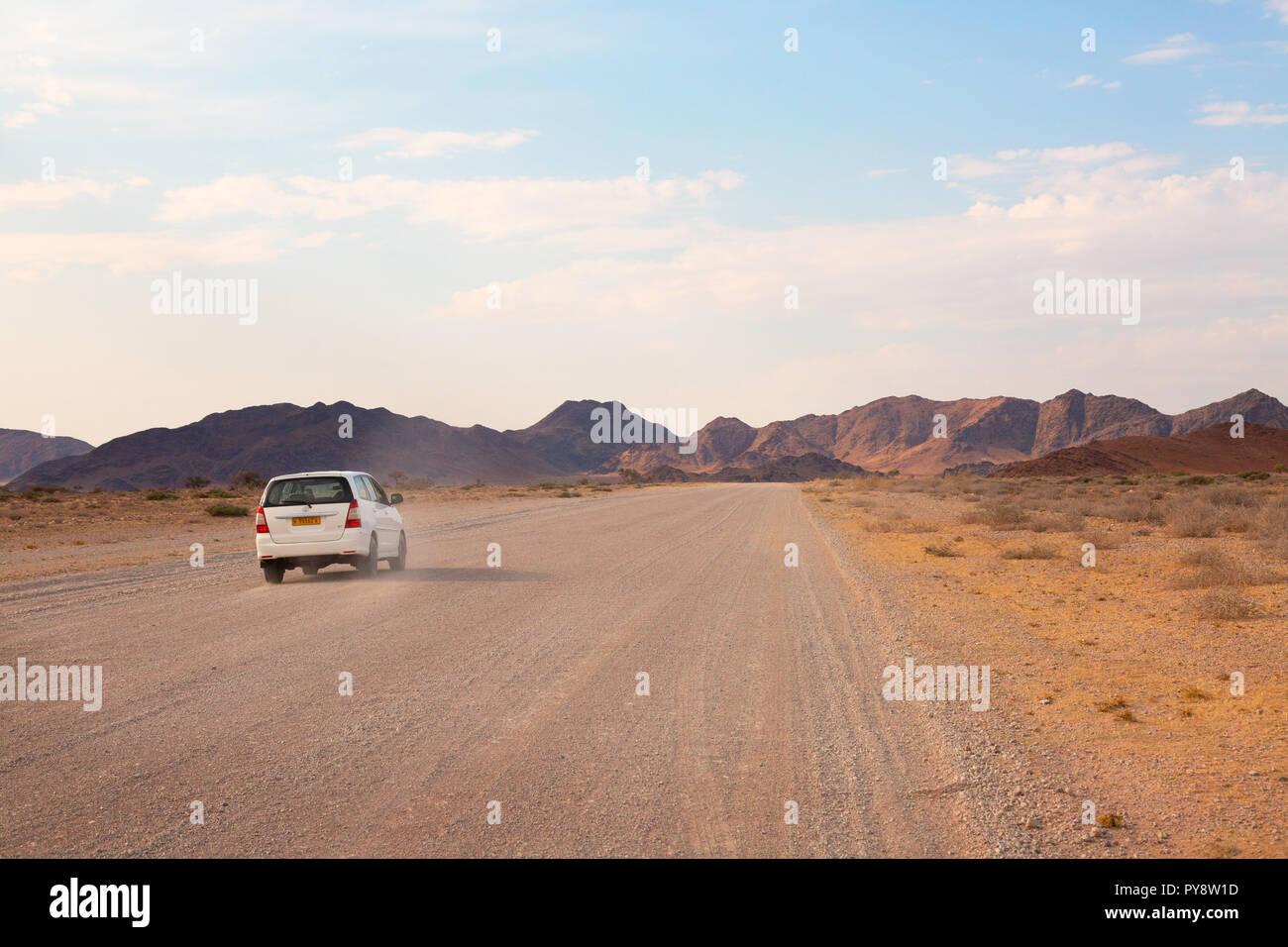 Namibia travel - A car driving on a gravel road through the Namib ...