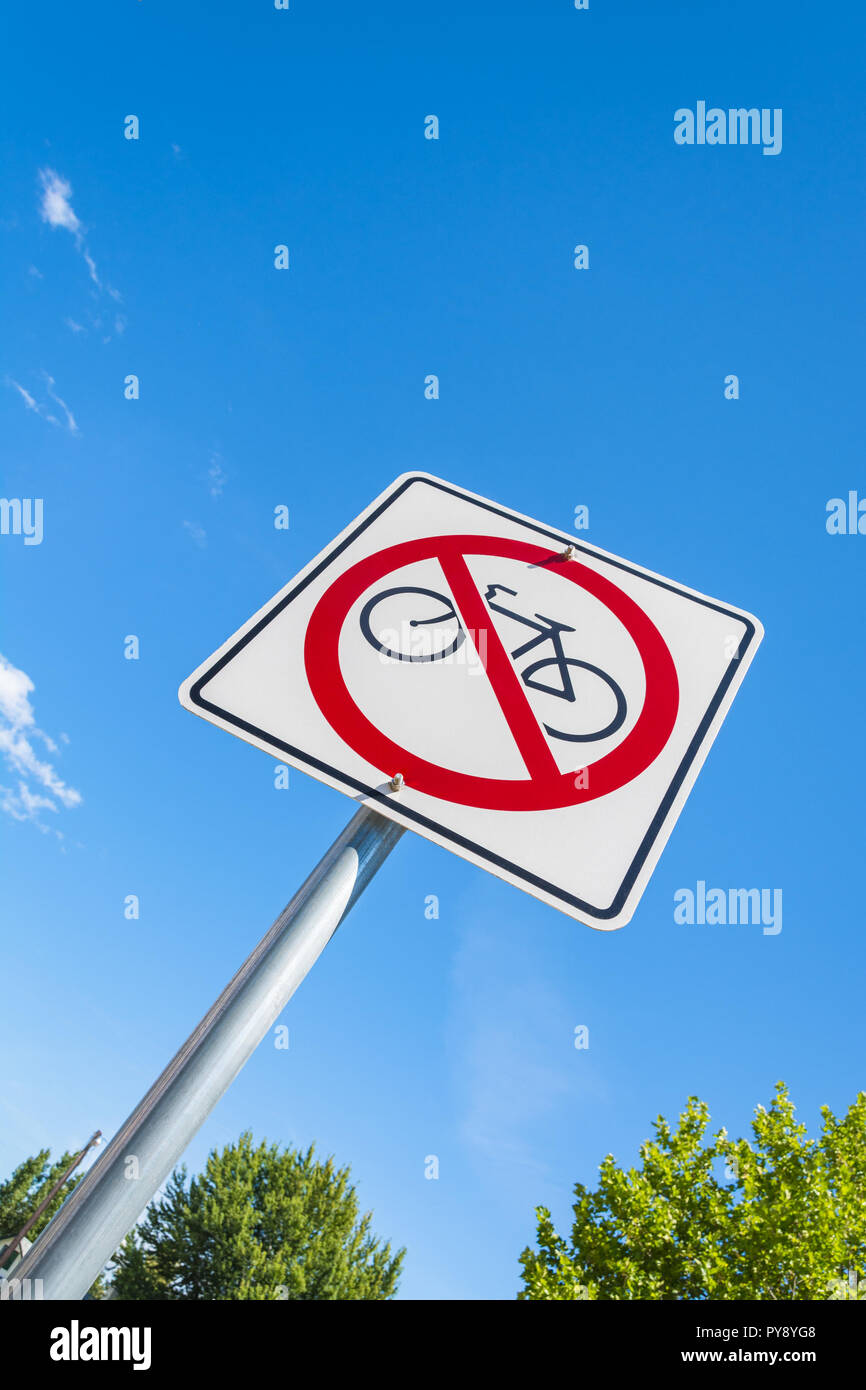 Road sign 'no bike' on blue sky background Stock Photo - Alamy