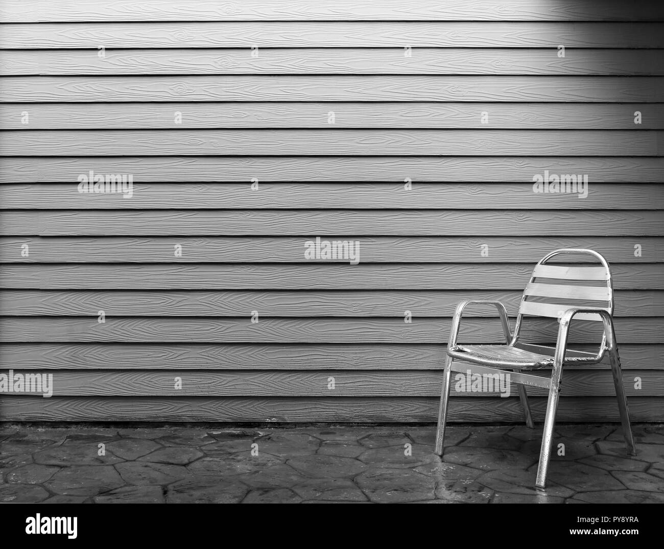 Wet lonely metal chair outside the house after raining Stock Photo - Alamy