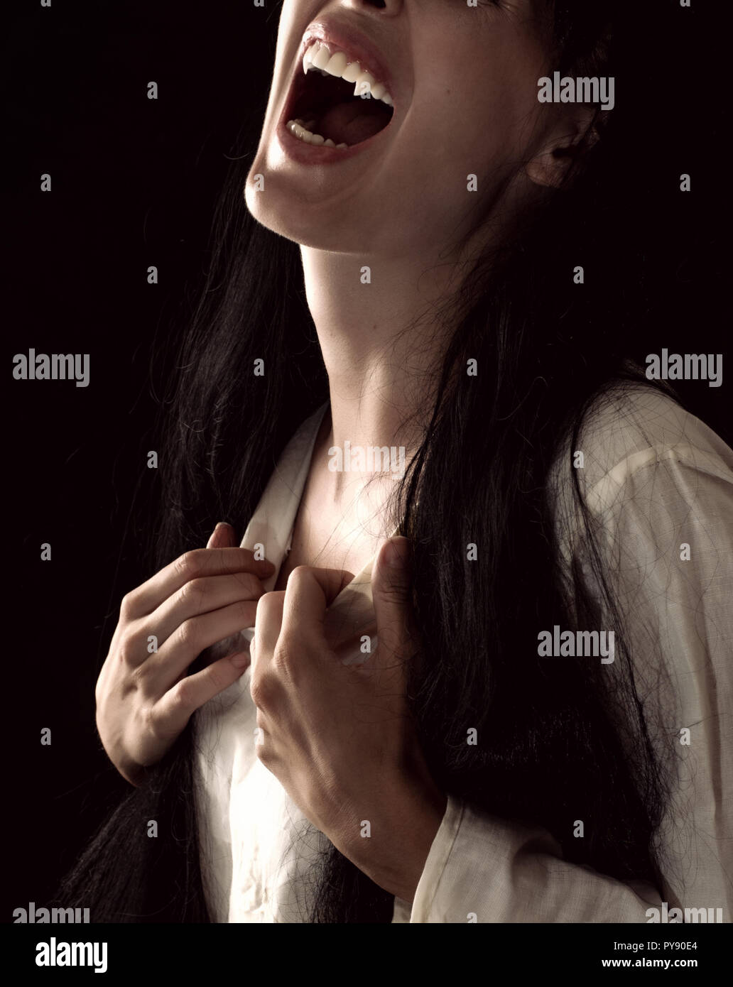 Halloween horror. Crazy bloody scary vampire girl with fangs screaming ...