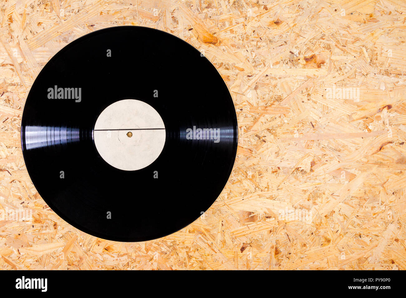 Black color vinyl record with white label on plywood background Stock ...