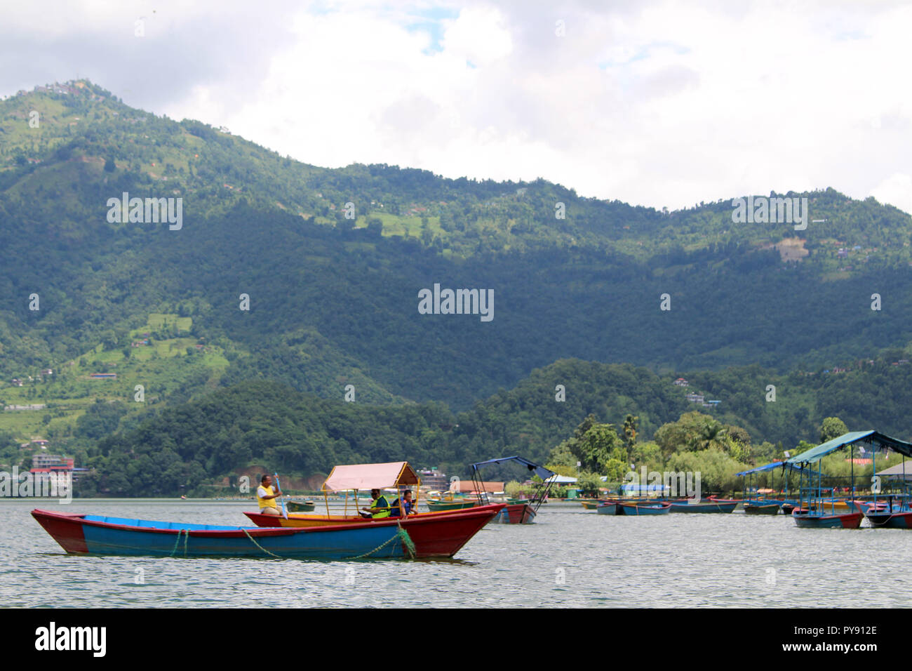 Boats around Phewa Lake and hills in Pokhara, a popular tourist ...