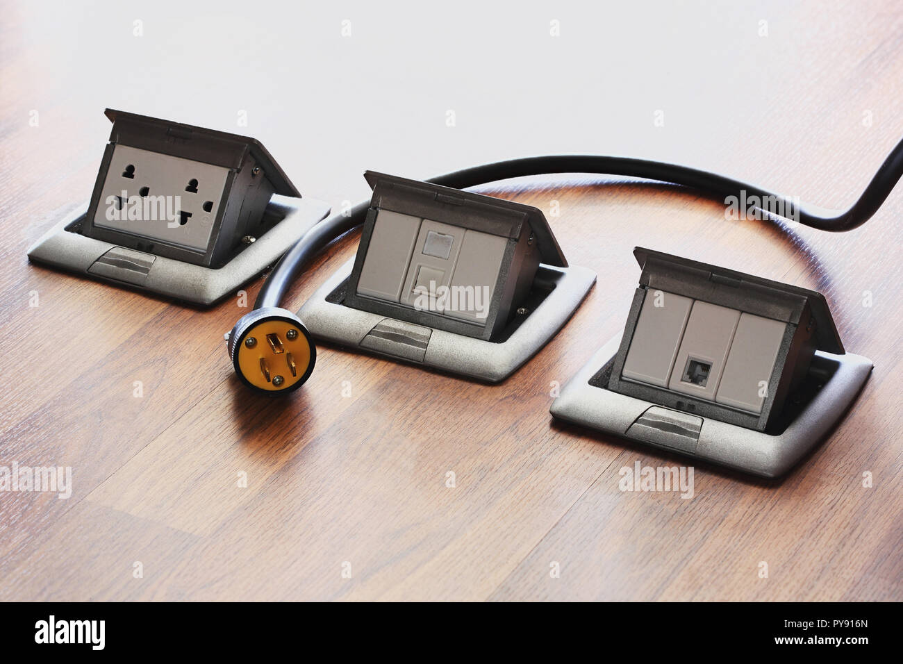 Pop-up floor plug socket and wire Stock Photo - Alamy