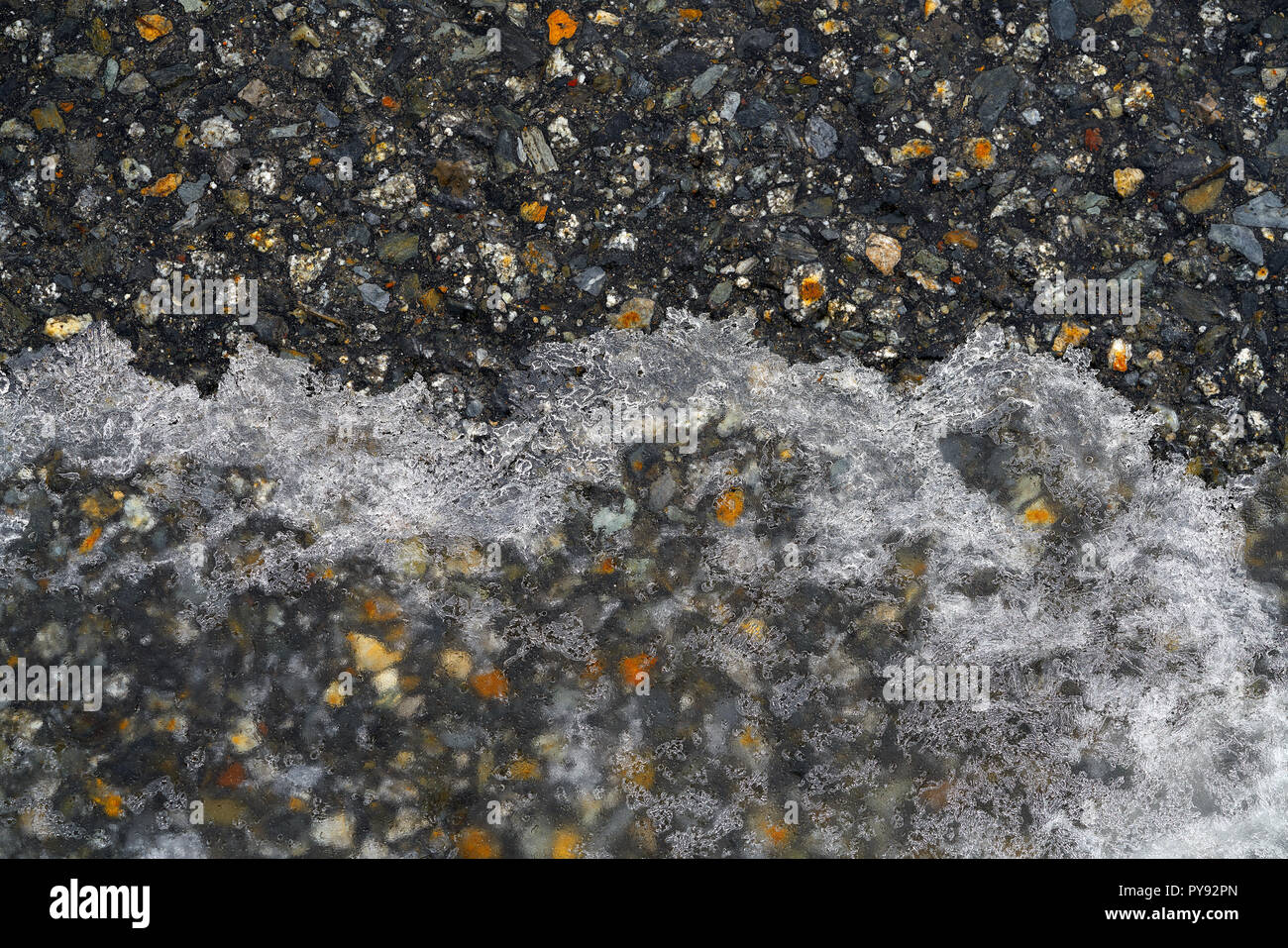 Iced asphalt road pavement detail in winter Stock Photo - Alamy