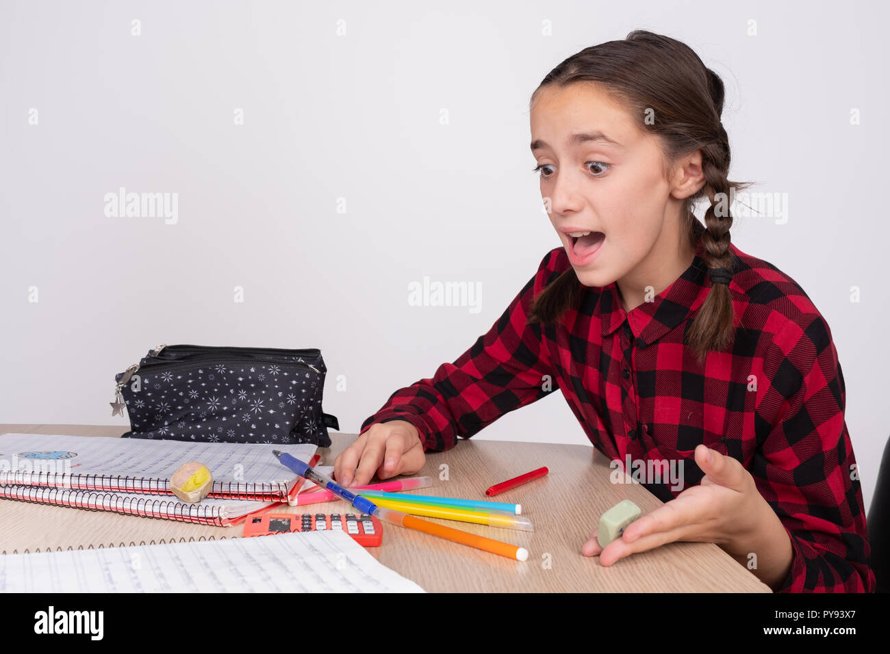 surprised girl doing homework from school Stock Photo - Alamy