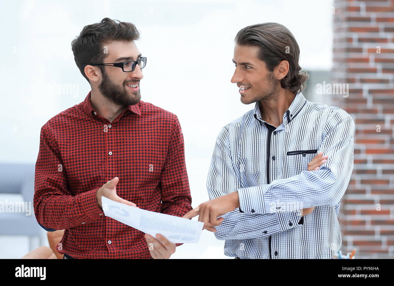 two office employee talking in the office Stock Photo - Alamy