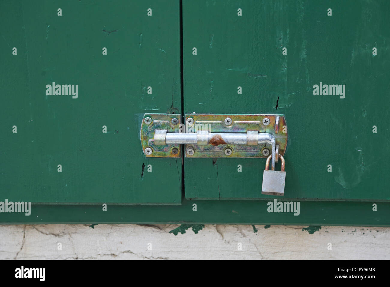 Bolt Lock With Padlock at Closed Green Window Stock Photo - Alamy