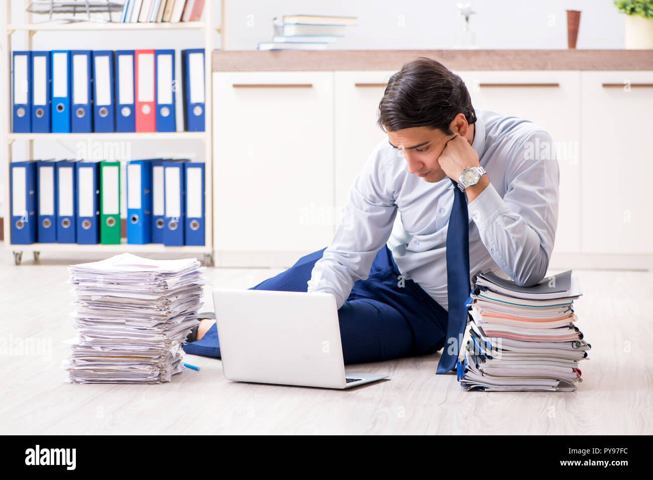 Extremely busy employee working in the office Stock Photo - Alamy