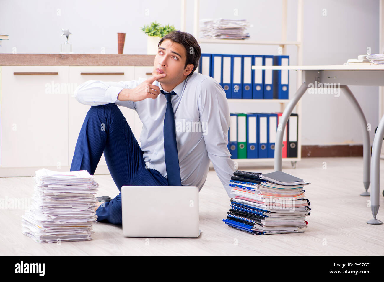 Extremely busy employee working in the office Stock Photo - Alamy