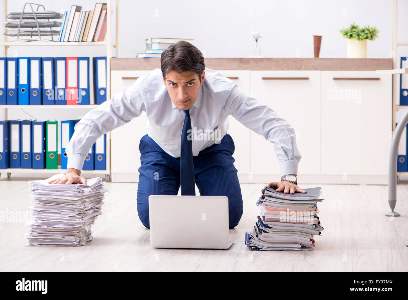 Extremely busy employee working in the office Stock Photo - Alamy