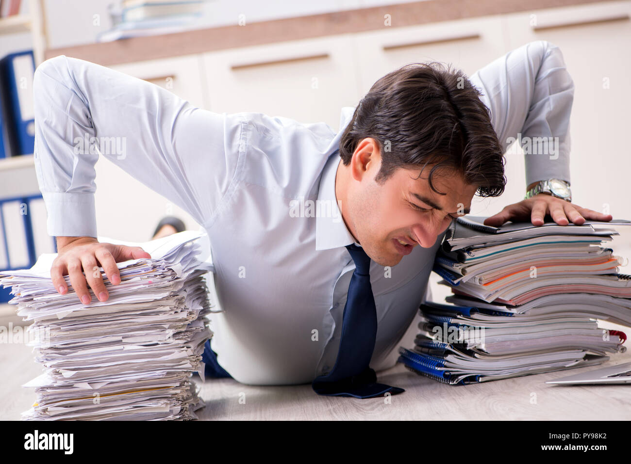 Extremely busy employee working in the office Stock Photo - Alamy