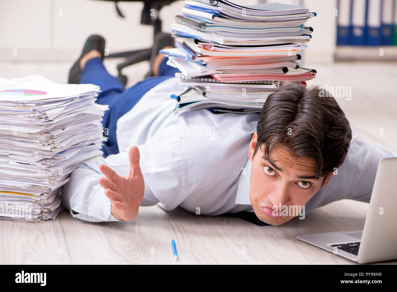 Extremely busy employee working in the office Stock Photo - Alamy