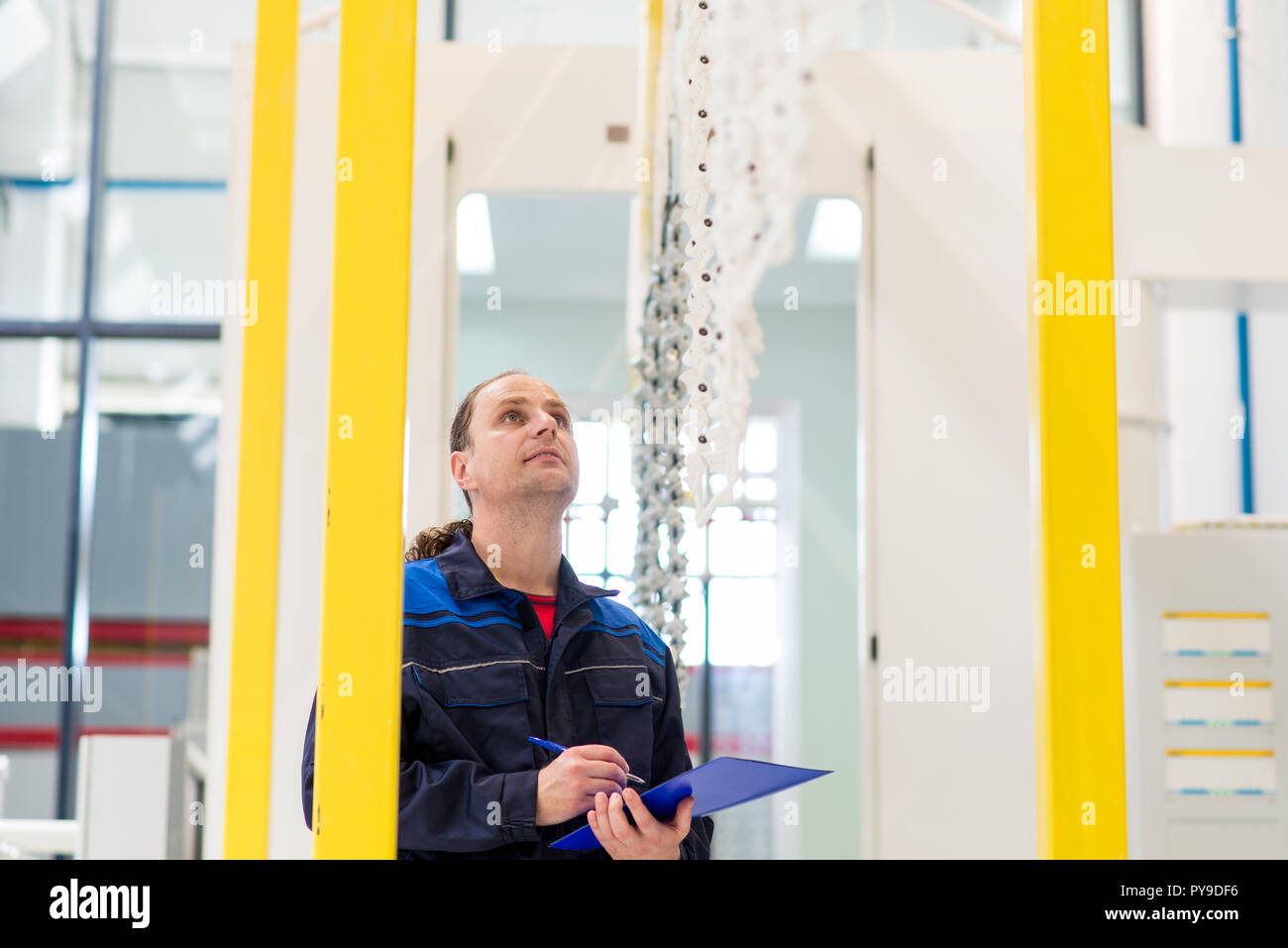 Factory worker checking products on production line. Worker taking ...