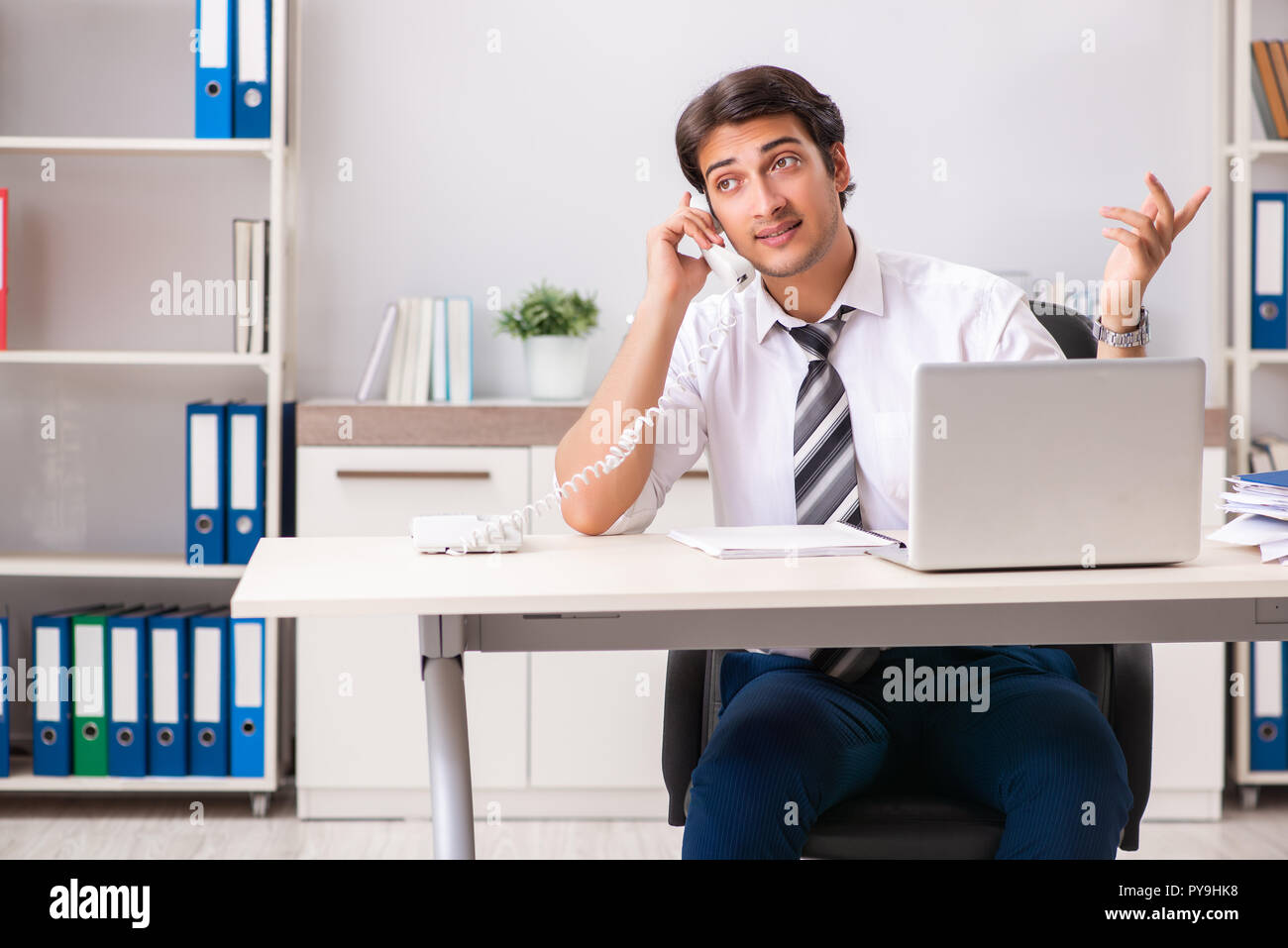 Young call center operator speaking on phone Stock Photo - Alamy