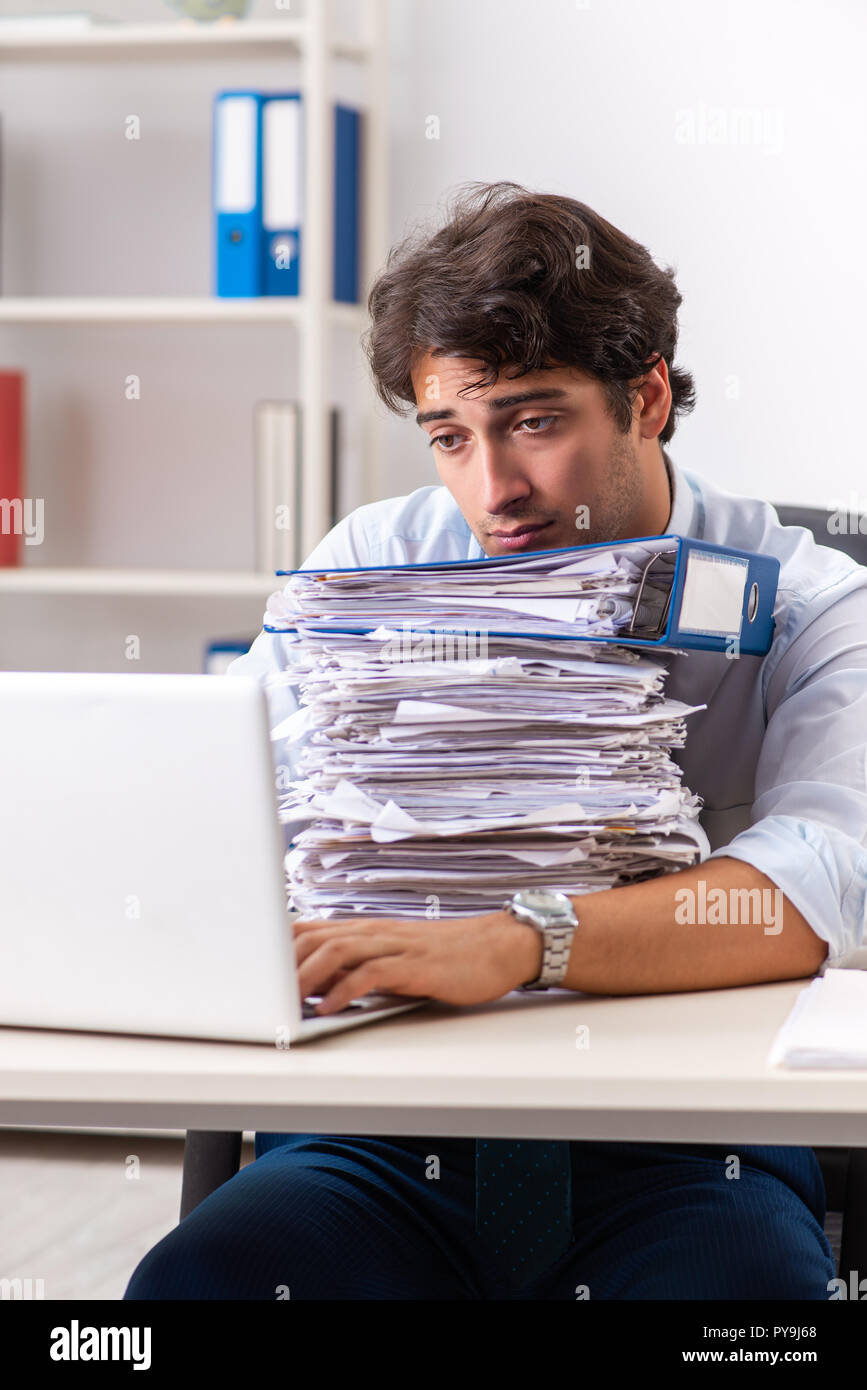 Overloaded busy employee with too much work and paperwork Stock Photo ...