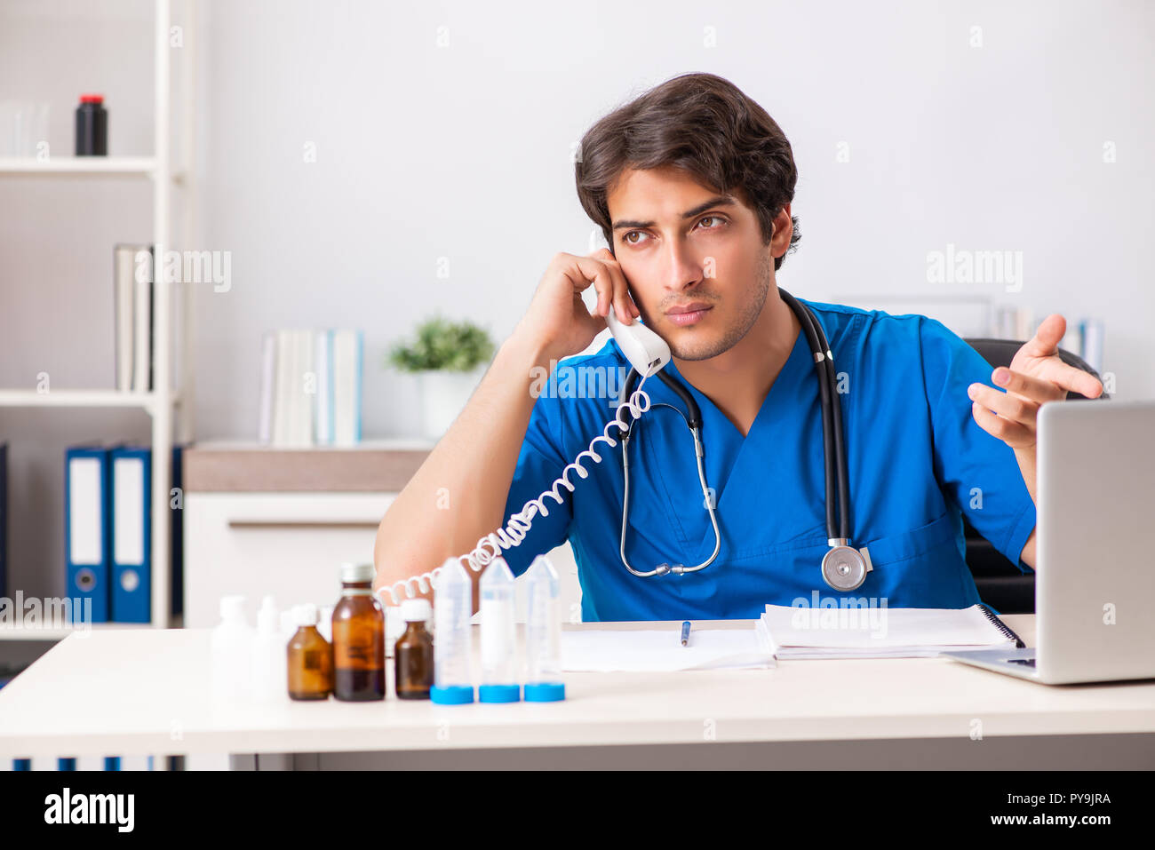 Doctor in telemedicine concept with phone Stock Photo - Alamy