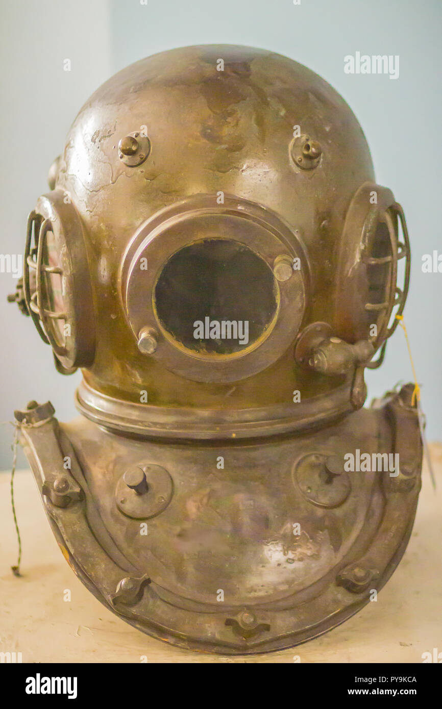 Antique metal scuba helmet, heavy diving equipment with air supply ...