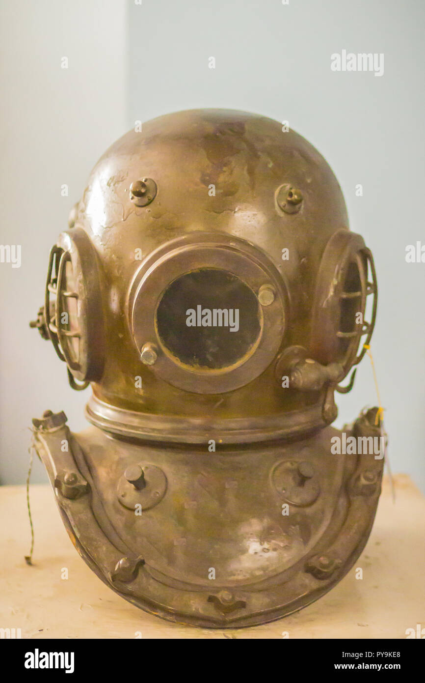 Antique metal scuba helmet, heavy diving equipment with air supply ...