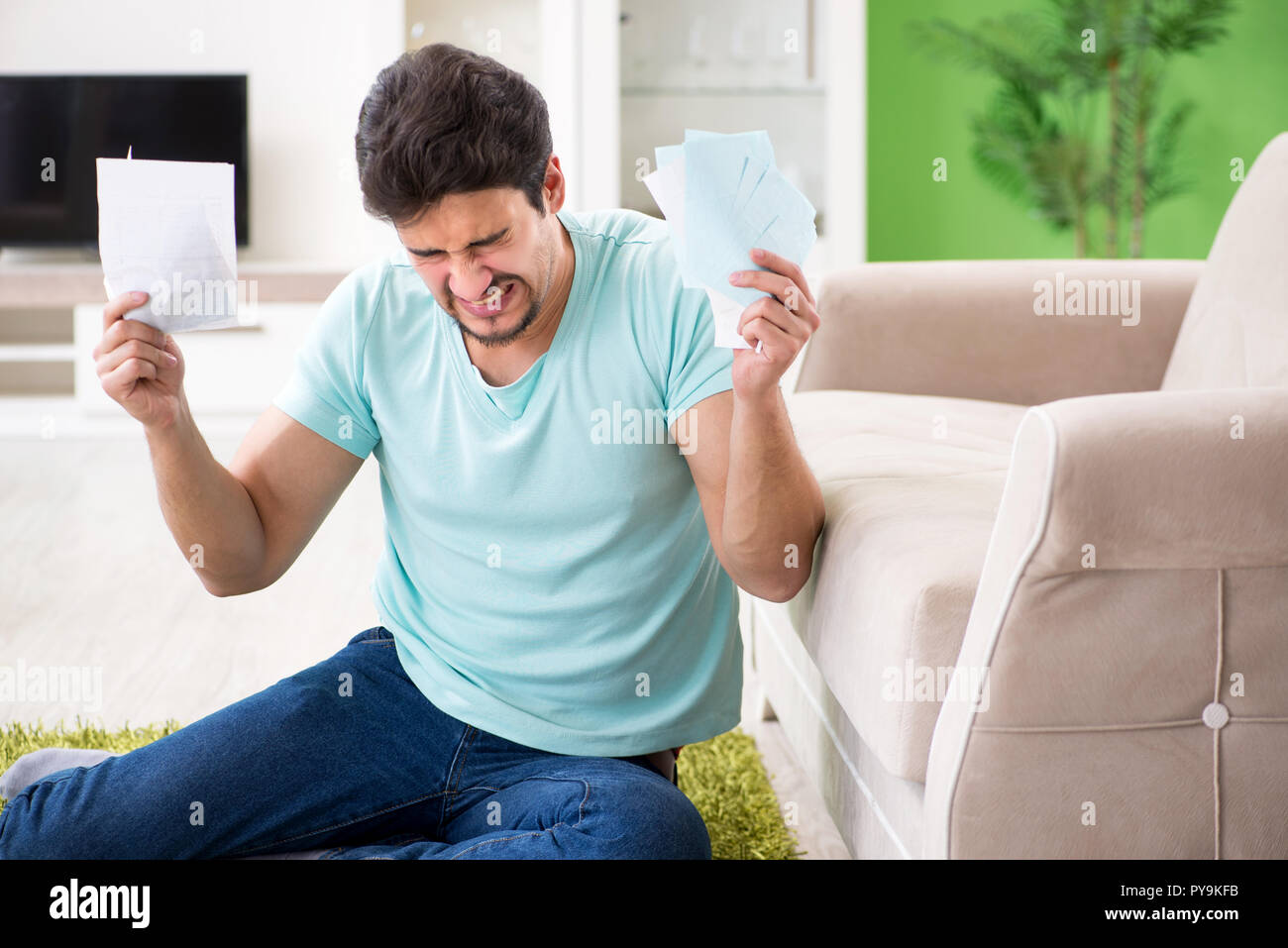 Young man struggling with personal finance and bills Stock Photo - Alamy