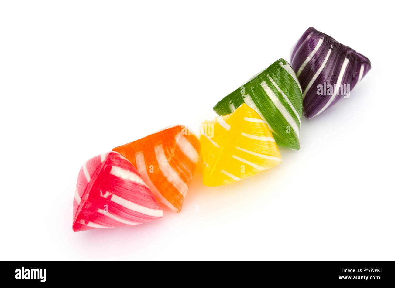 Rainbow colored candy in a row Stock Photo - Alamy