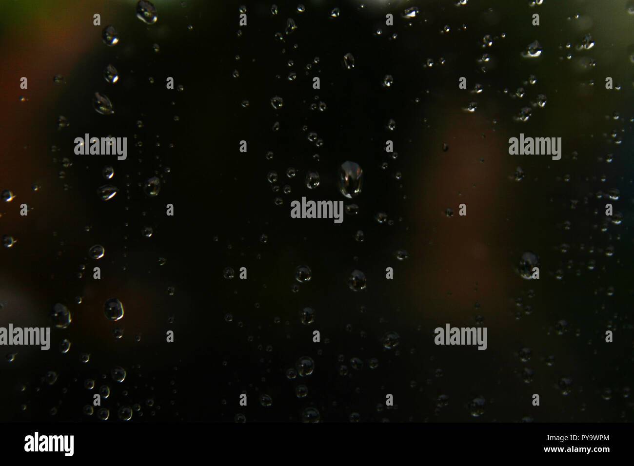 Rain drops on a window with reflections Stock Photo - Alamy