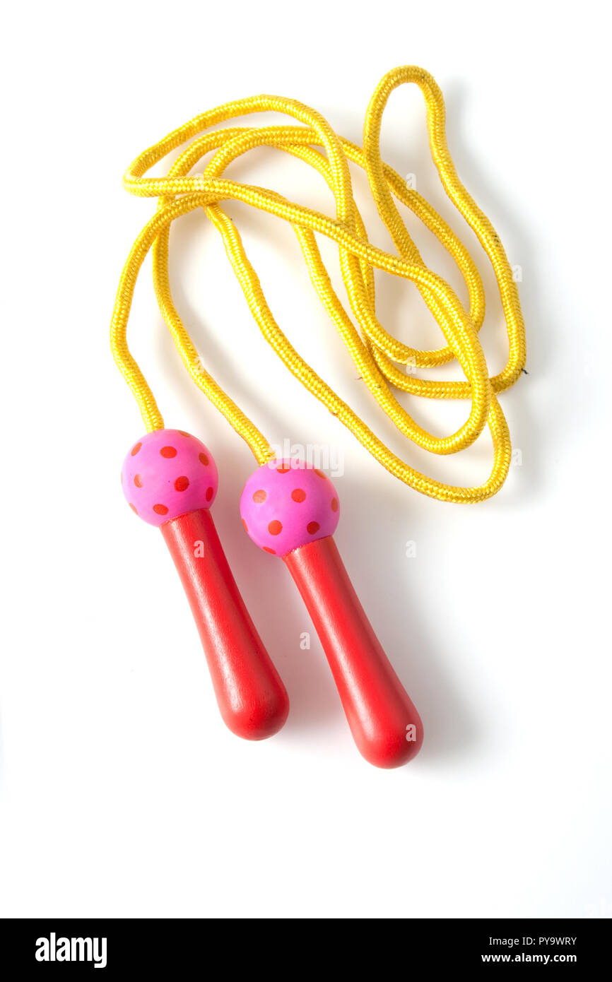 Yellow skipping rope on white Stock Photo - Alamy