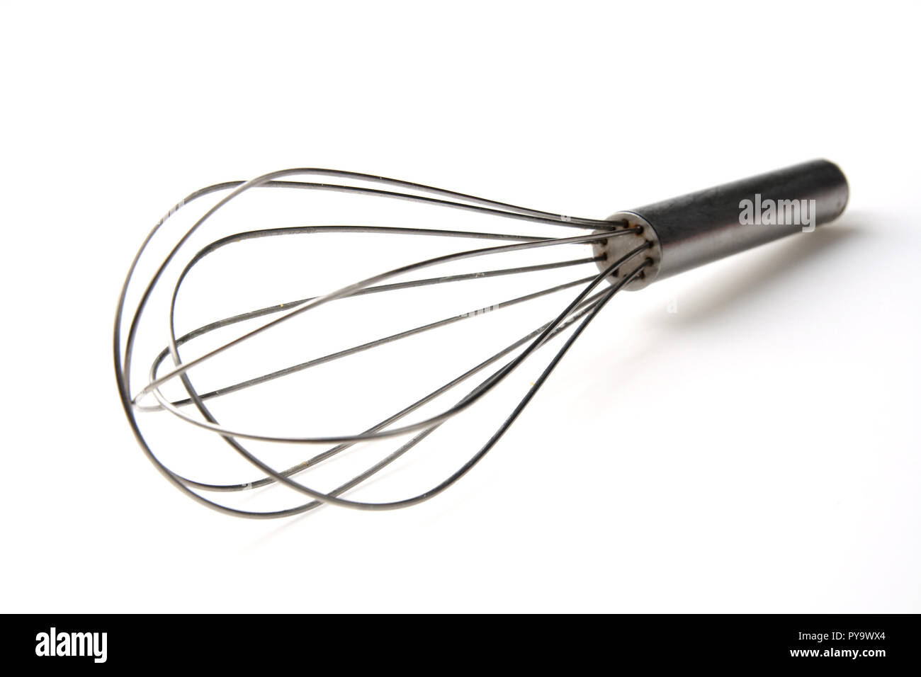 Stainless steel whisk on white Stock Photo - Alamy
