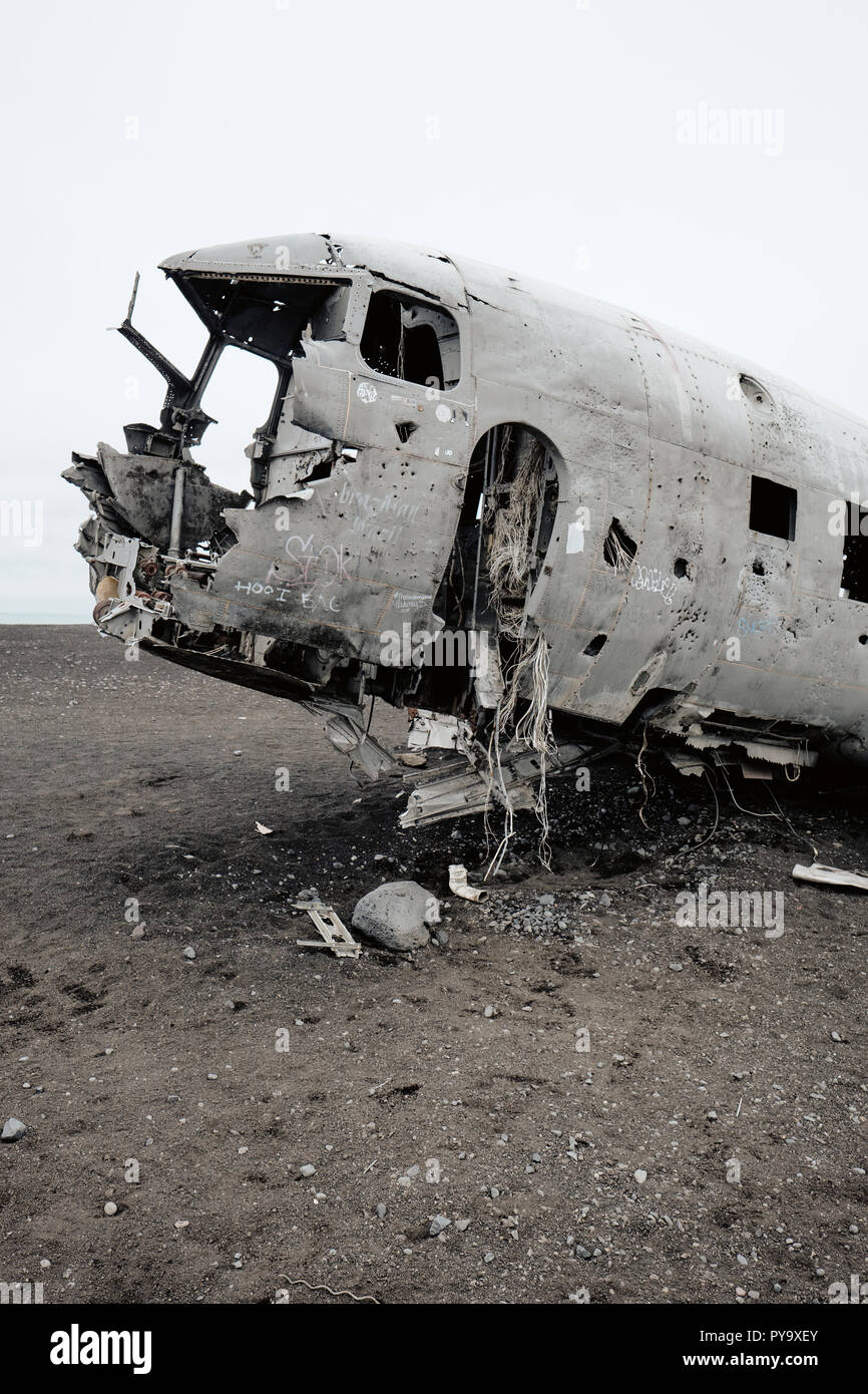 The remote and eerie plane wreckage in the black sand plain desert of ...