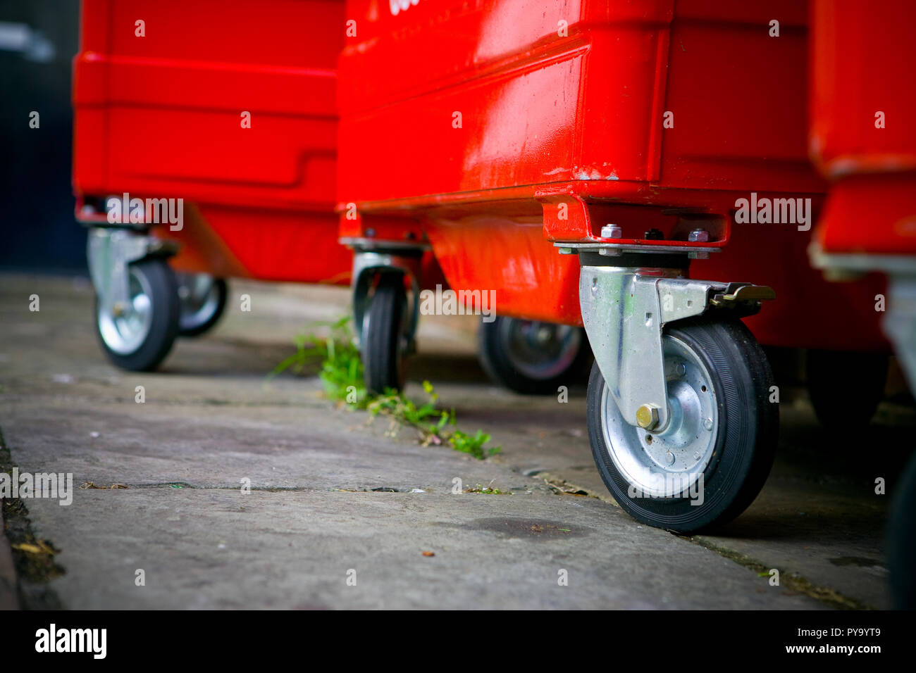 Castor wheels of bright red commercial metal waste disposal bin Stock ...