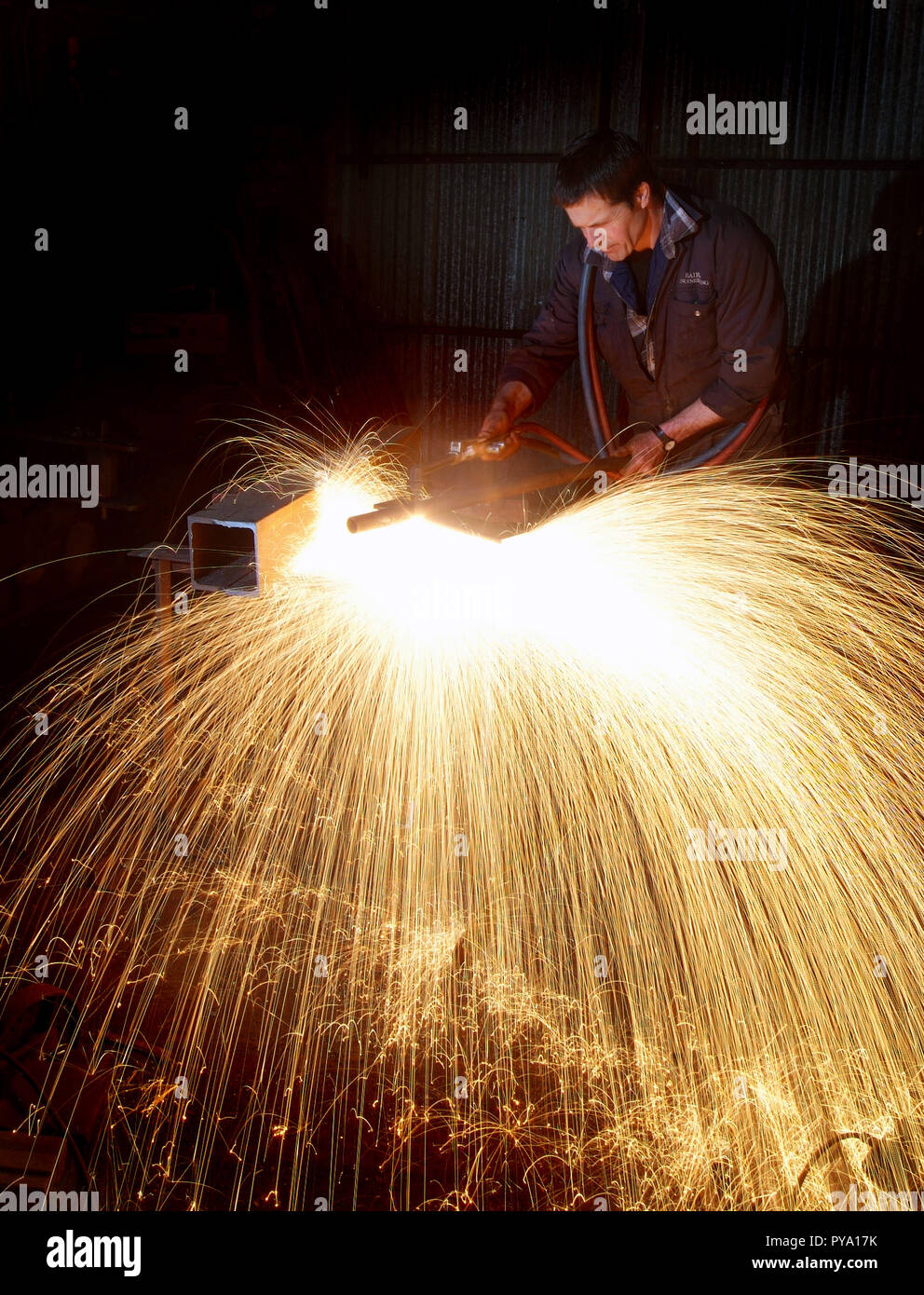 Male welder at work in his engineering workshop oxyacetylene welding ...