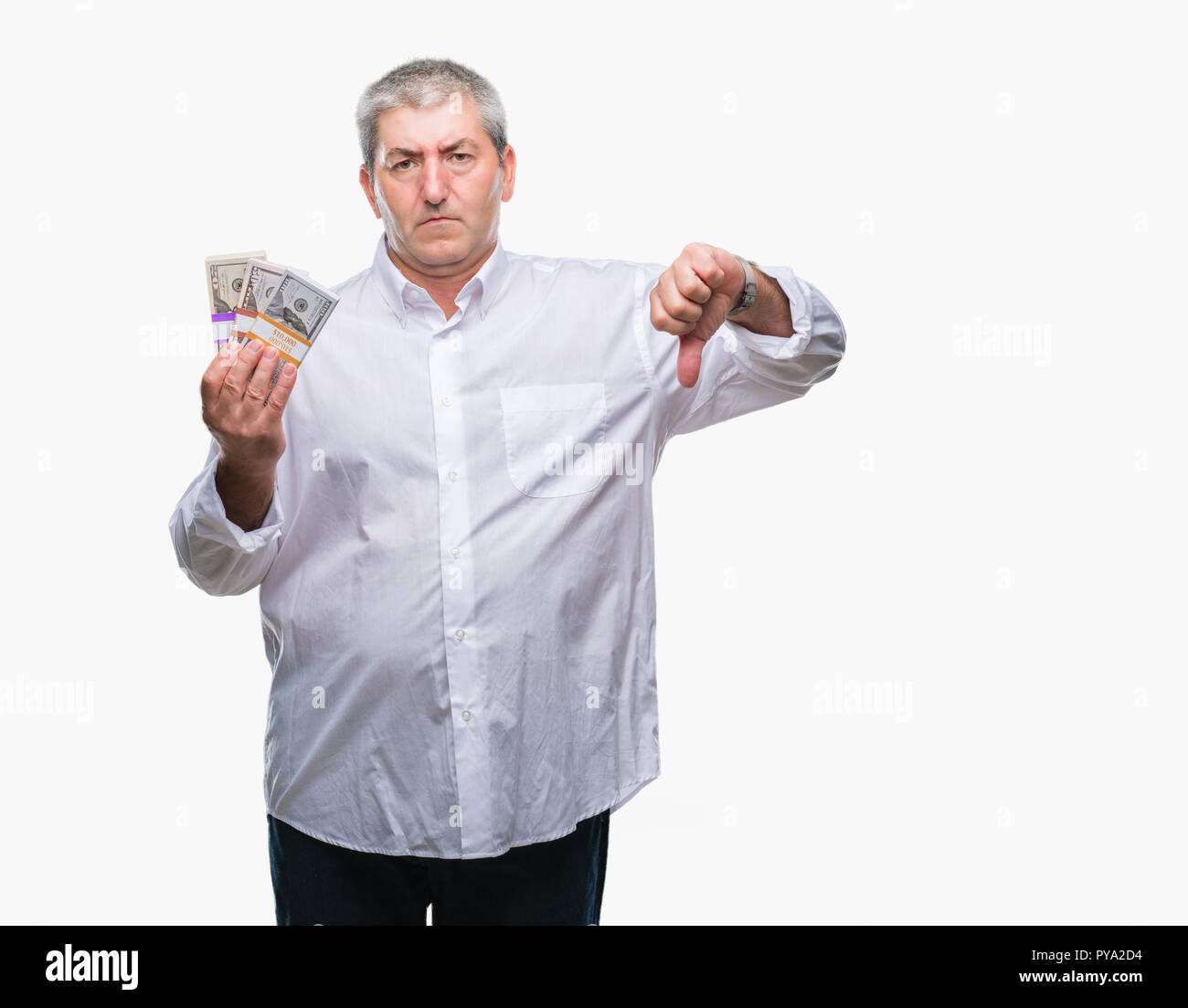 Handsome senior man holding bunch of money over isolated background ...