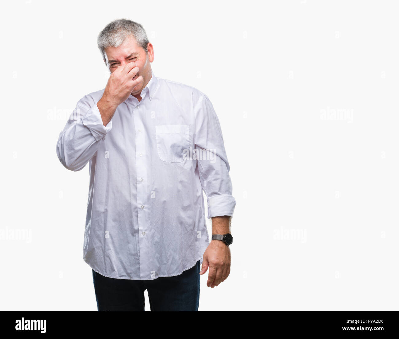 Handsome senior man over isolated background smelling something stinky ...