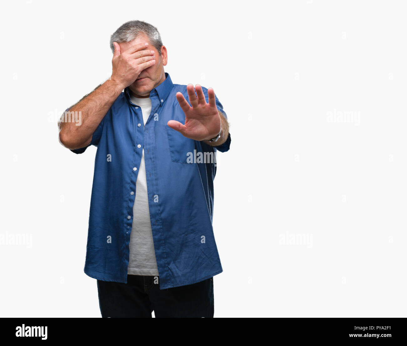 Handsome senior man over isolated background covering eyes with hands ...