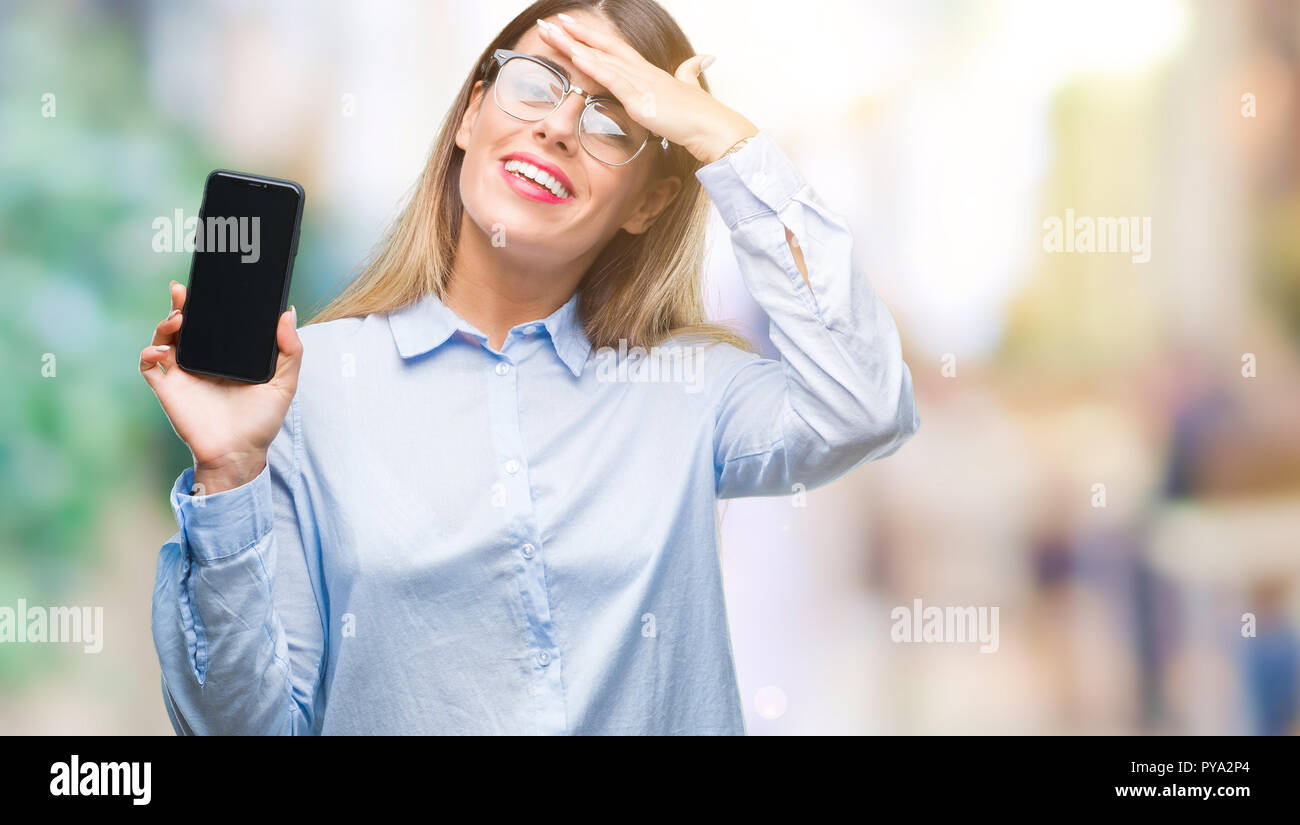 Young beautiful business woman showing blank screen of smartphone over ...