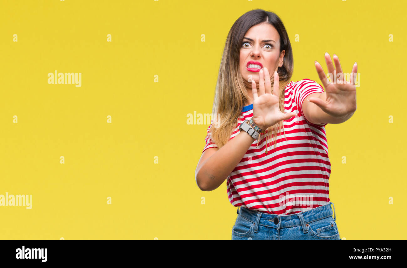 Young beautiful woman casual look over isolated background afraid and ...